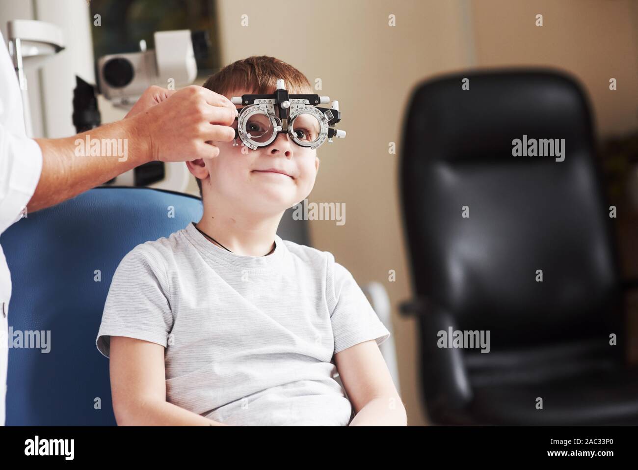 Checking different lenses. Child sitting in the doctor's cabinet and ...