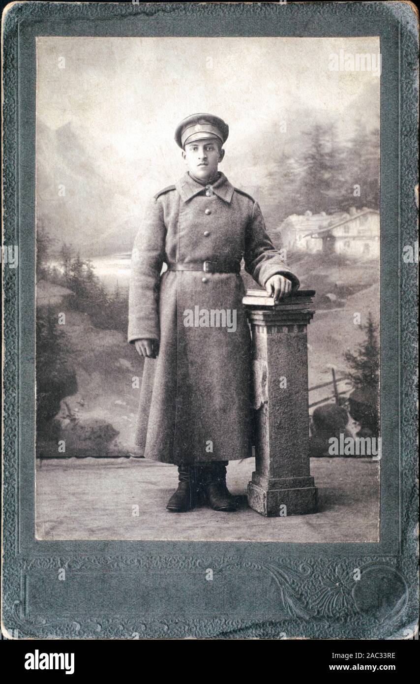 Vintage photo of Russian man in greatcoat in photo studio. Photo was ...