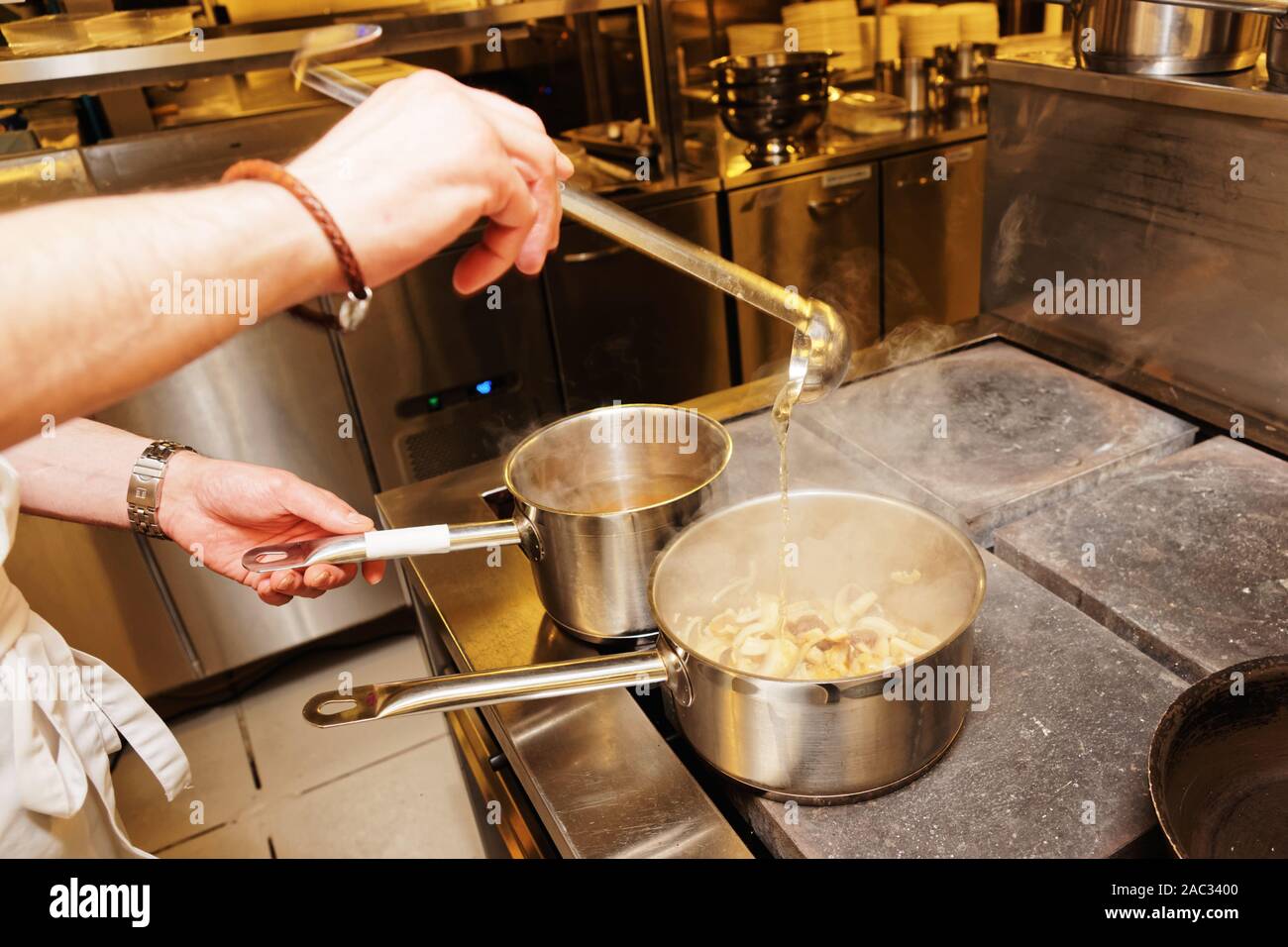 Pouring broth in pot hi-res stock photography and images - Alamy