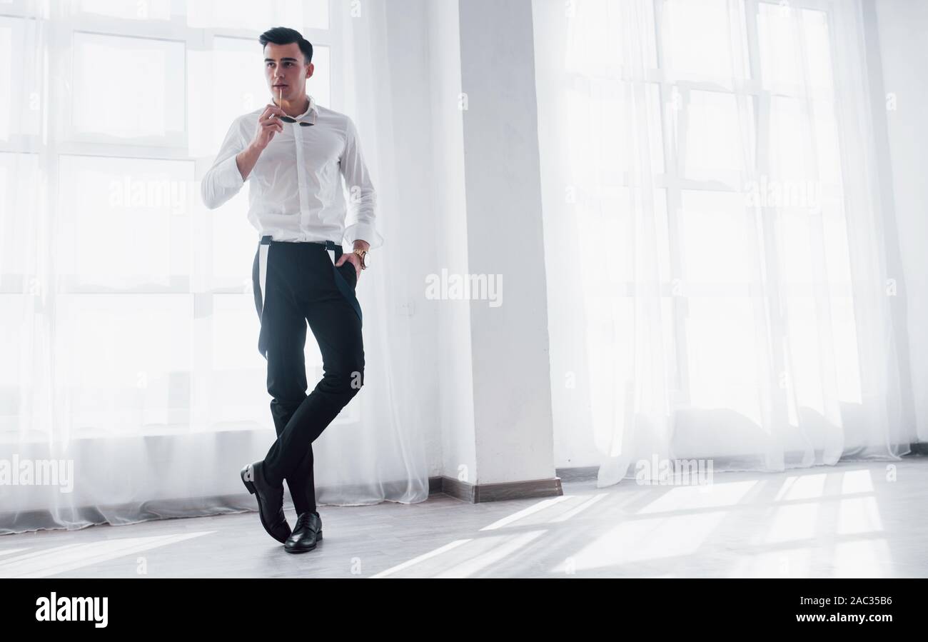 Model posture. Full length of beautiful young man holding his ...