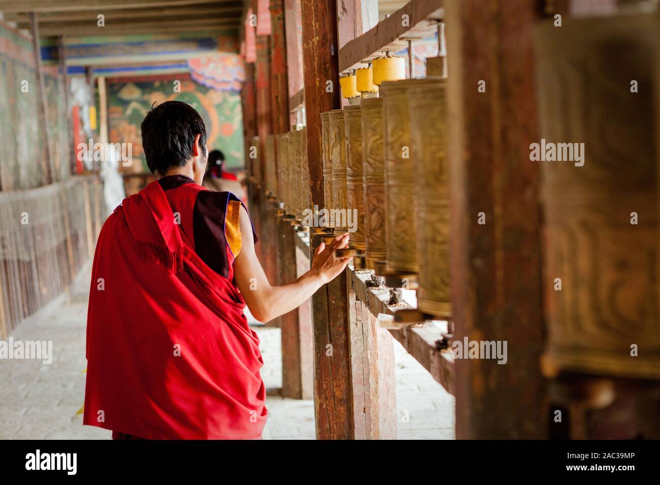 Tibet - September 23 2010: monk rotates the sacred prayer rolls, inside ...