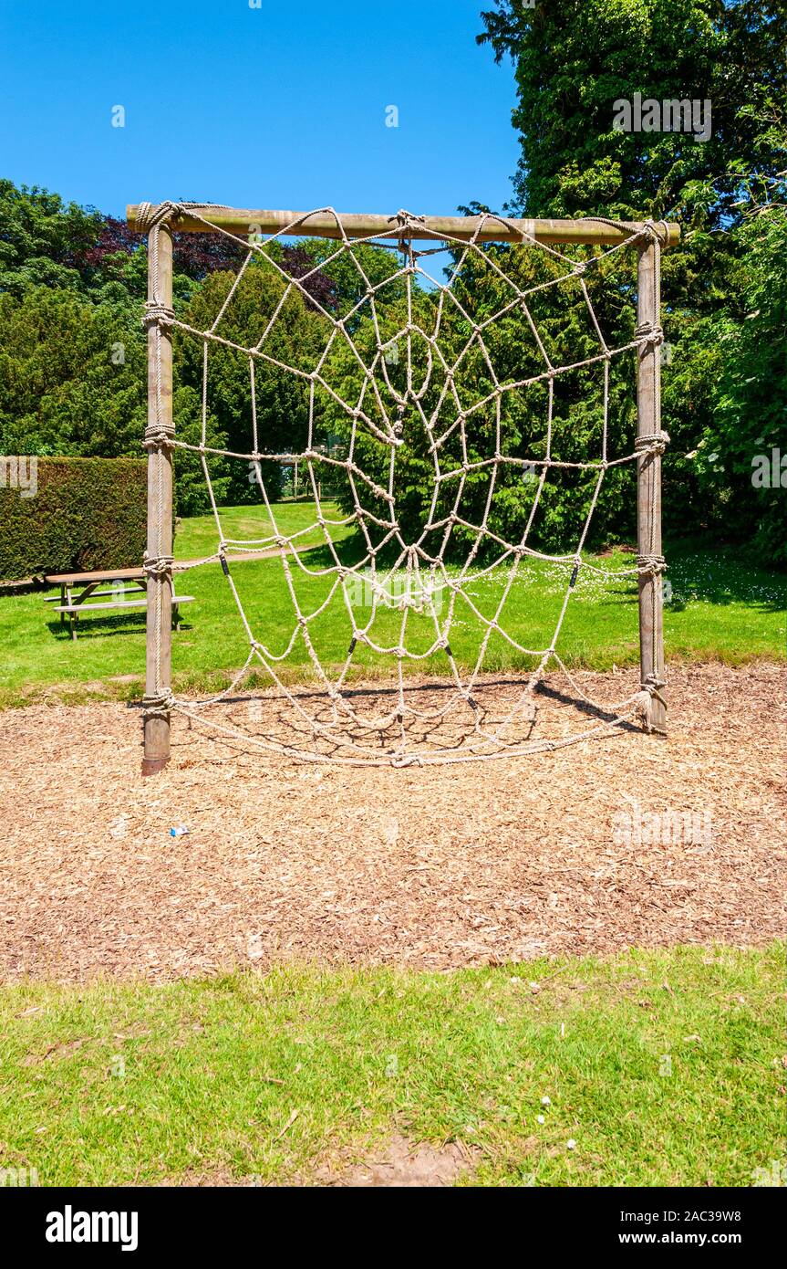 A climbing frame for children consisting of three wooden posts ...