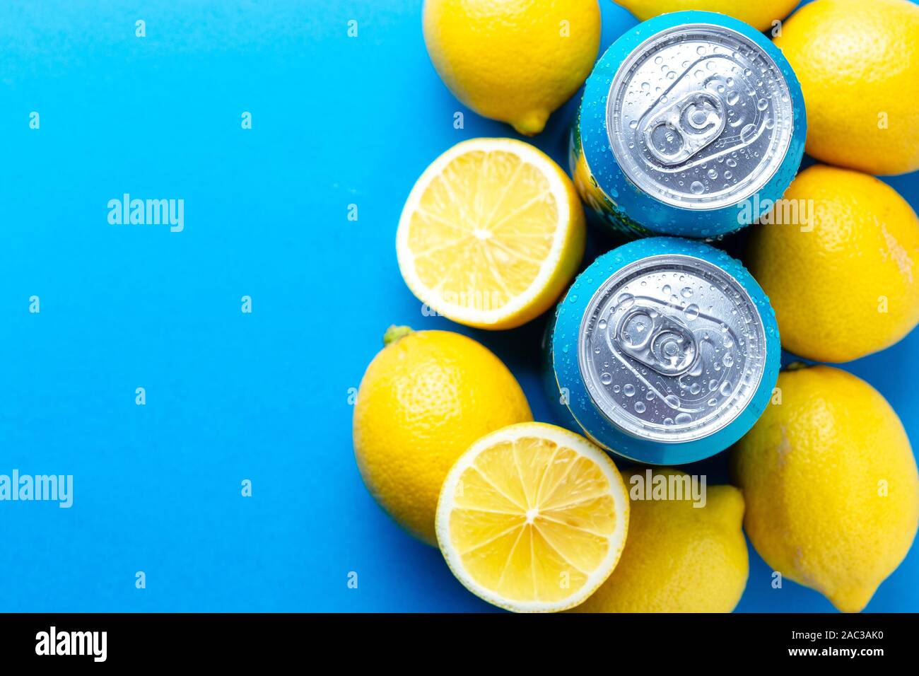 Soda cans with condensation drops and lemons over blue background Stock ...