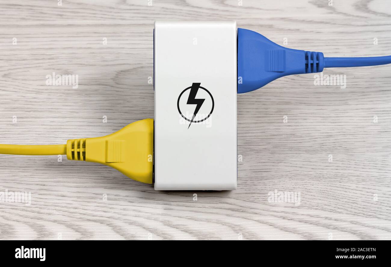 A blue cable and a yellow one connected to a multiple socket over a ...