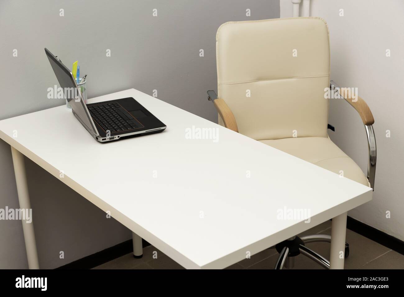 laptop on an empty table. traditional workplace for a doctor or ...