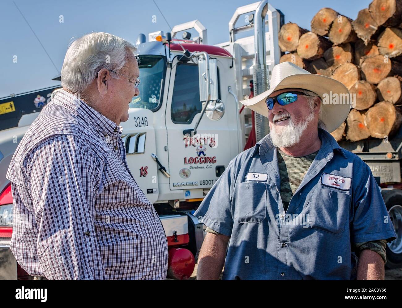 Tracy Gunter Jr., owner of Tracy’s Logging, talks with a driver as he ...