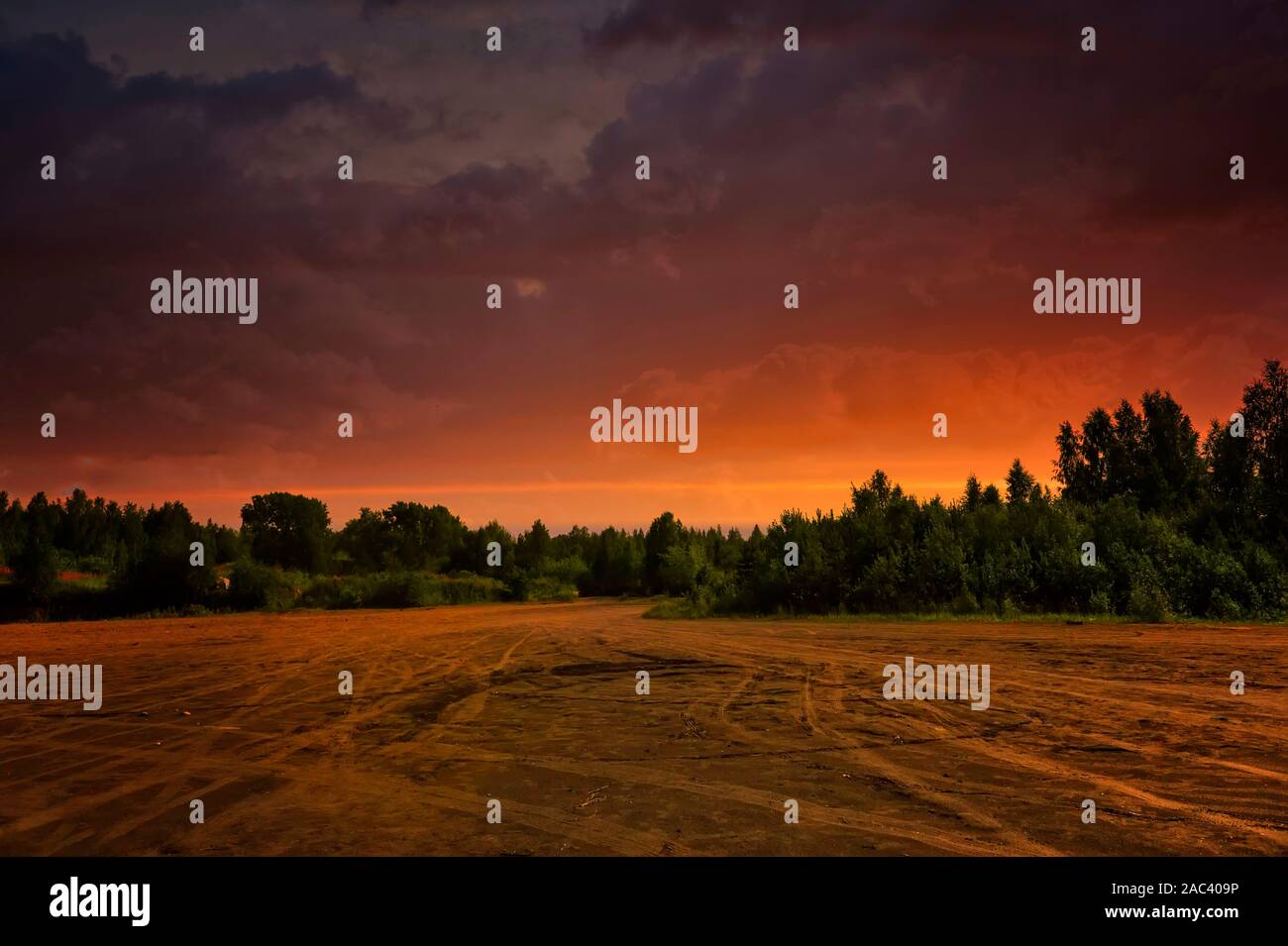 Summer evening sand dune landscape against the backdrop of a colorful ...