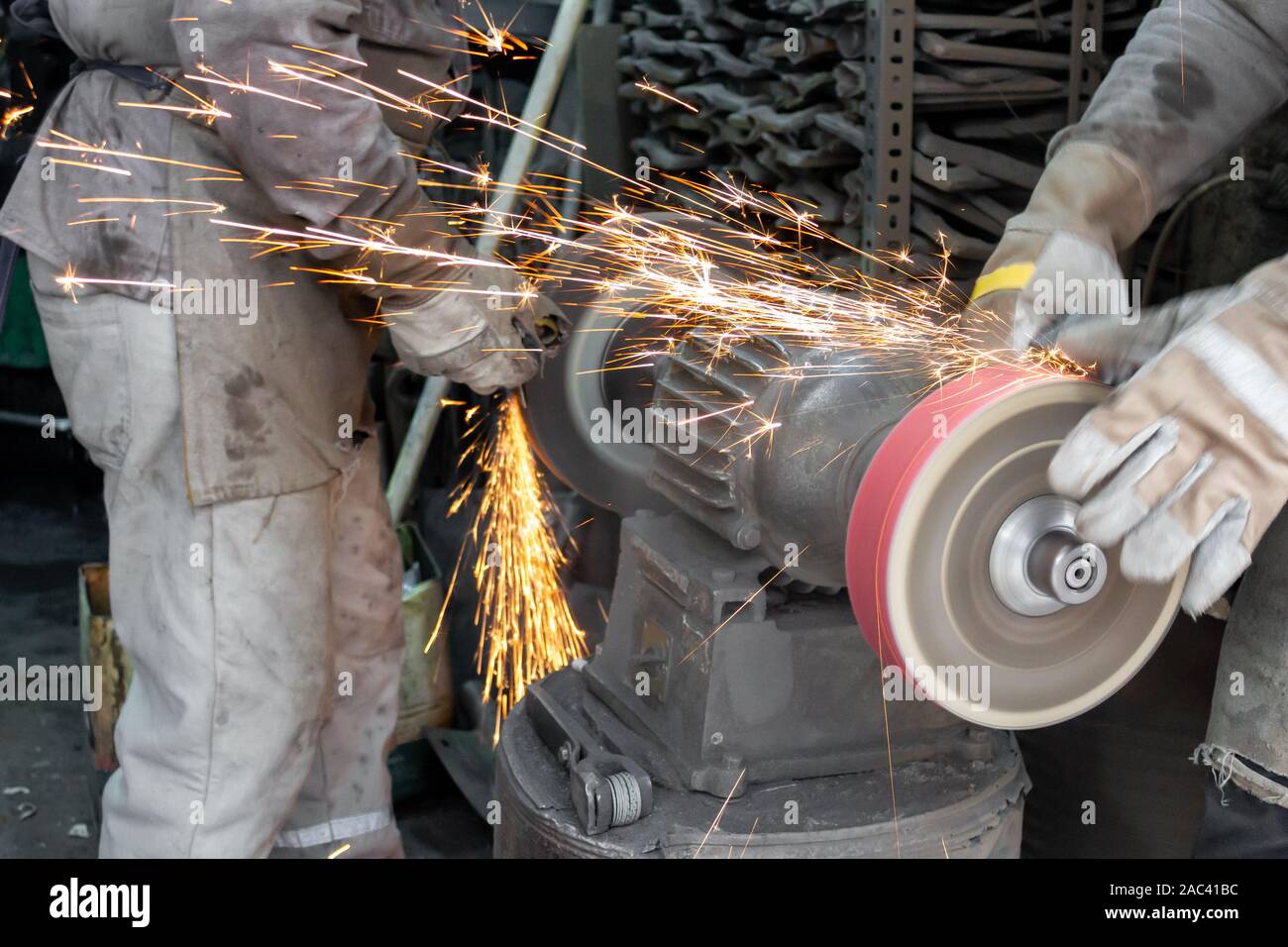 Two blacksmiths works by hand in blacksmith shop. Iron grinding Stock ...
