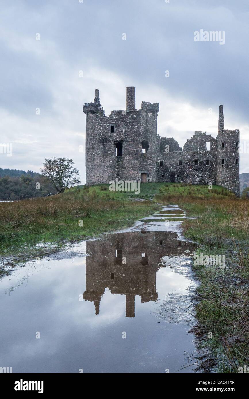 Old castle on the hill, colorful autumn around and overcast weather ...