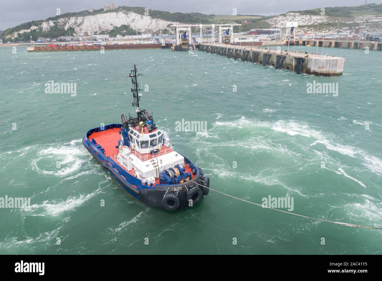 A tugboat helps the ferry maneuver Stock Photo - Alamy