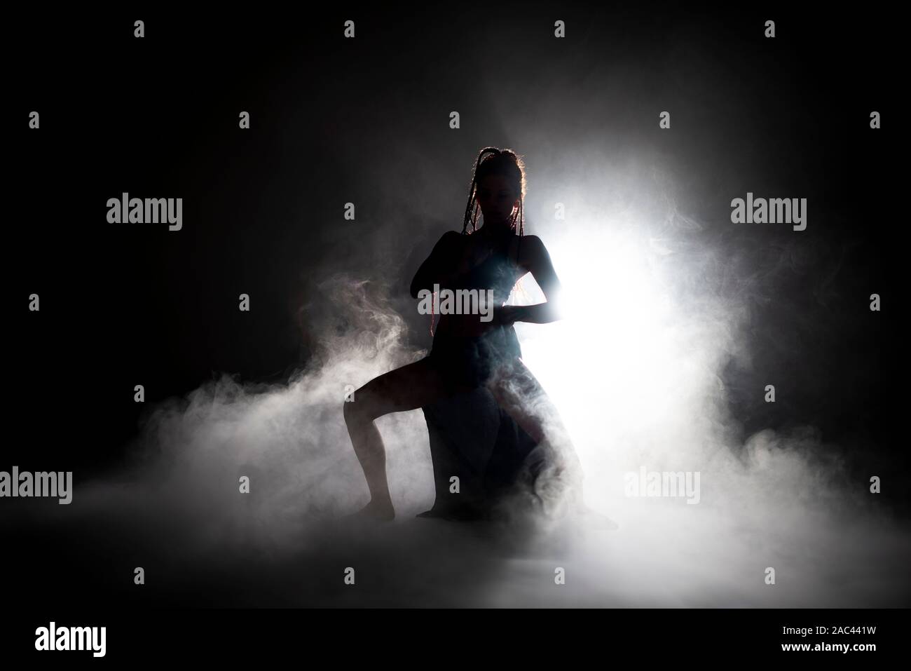 Silhouette dancer woman performing dance figures in fog Stock Photo - Alamy