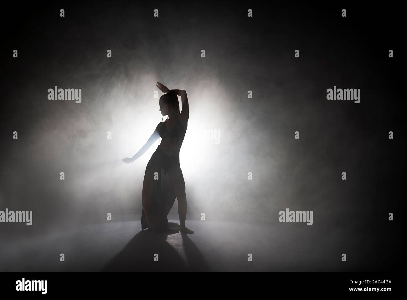 Silhouette dancer performing dance figures in fog Stock Photo - Alamy