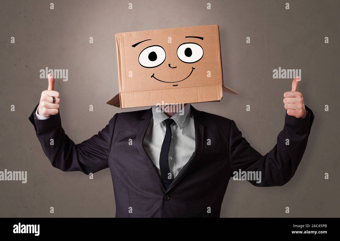 Young boy standing and gesturing with a cardboard box on his head Stock ...
