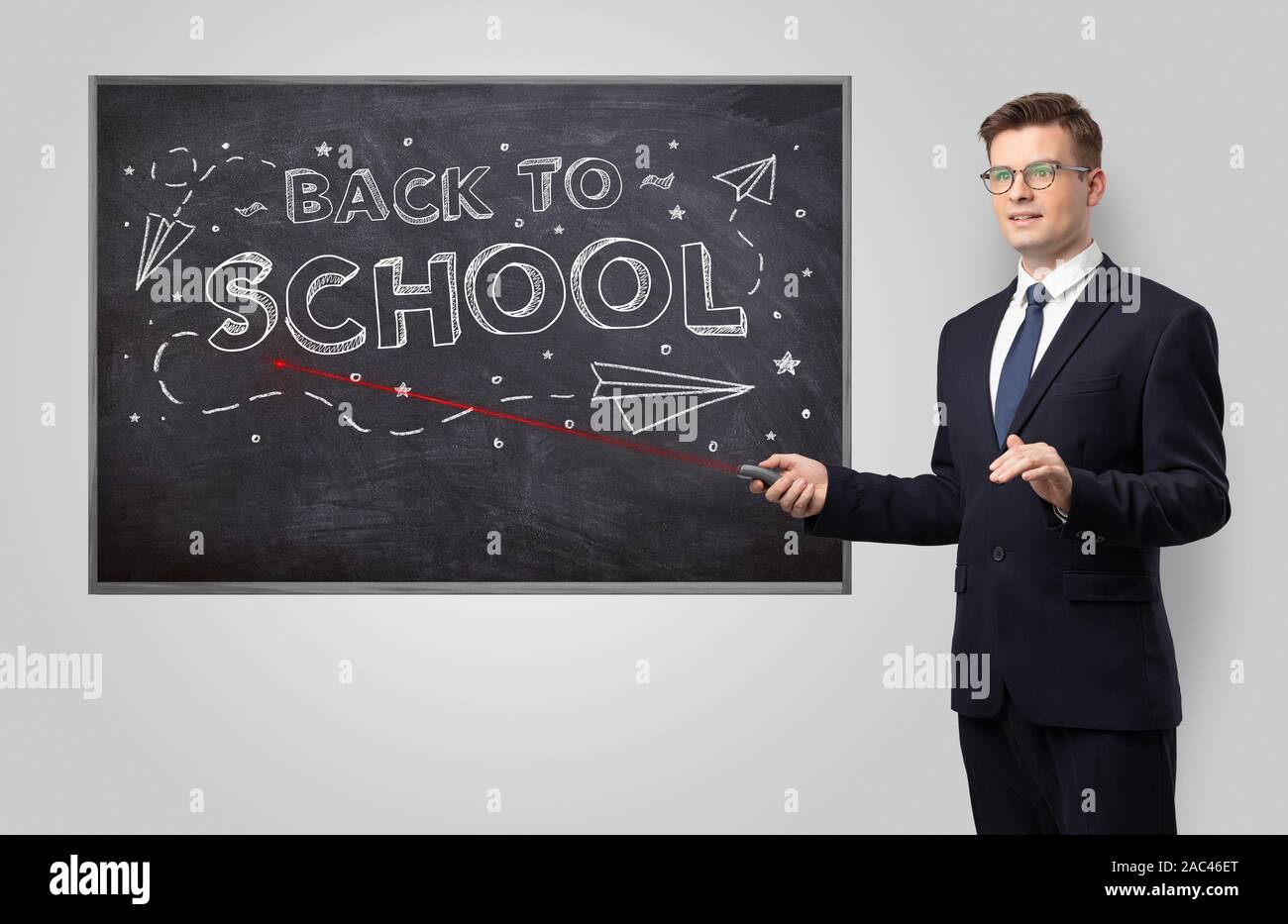 Handsome young teacher with laser pointer teaching Stock Photo - Alamy