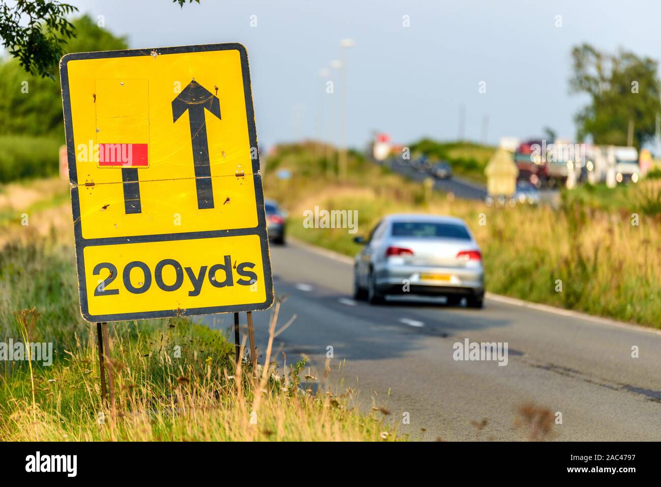 200 yards roadworks warning sign on UK motorway at evening with traffic ...