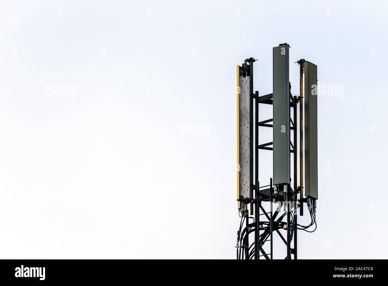 mobile network operator mast over cloudy sky in uk Stock Photo - Alamy