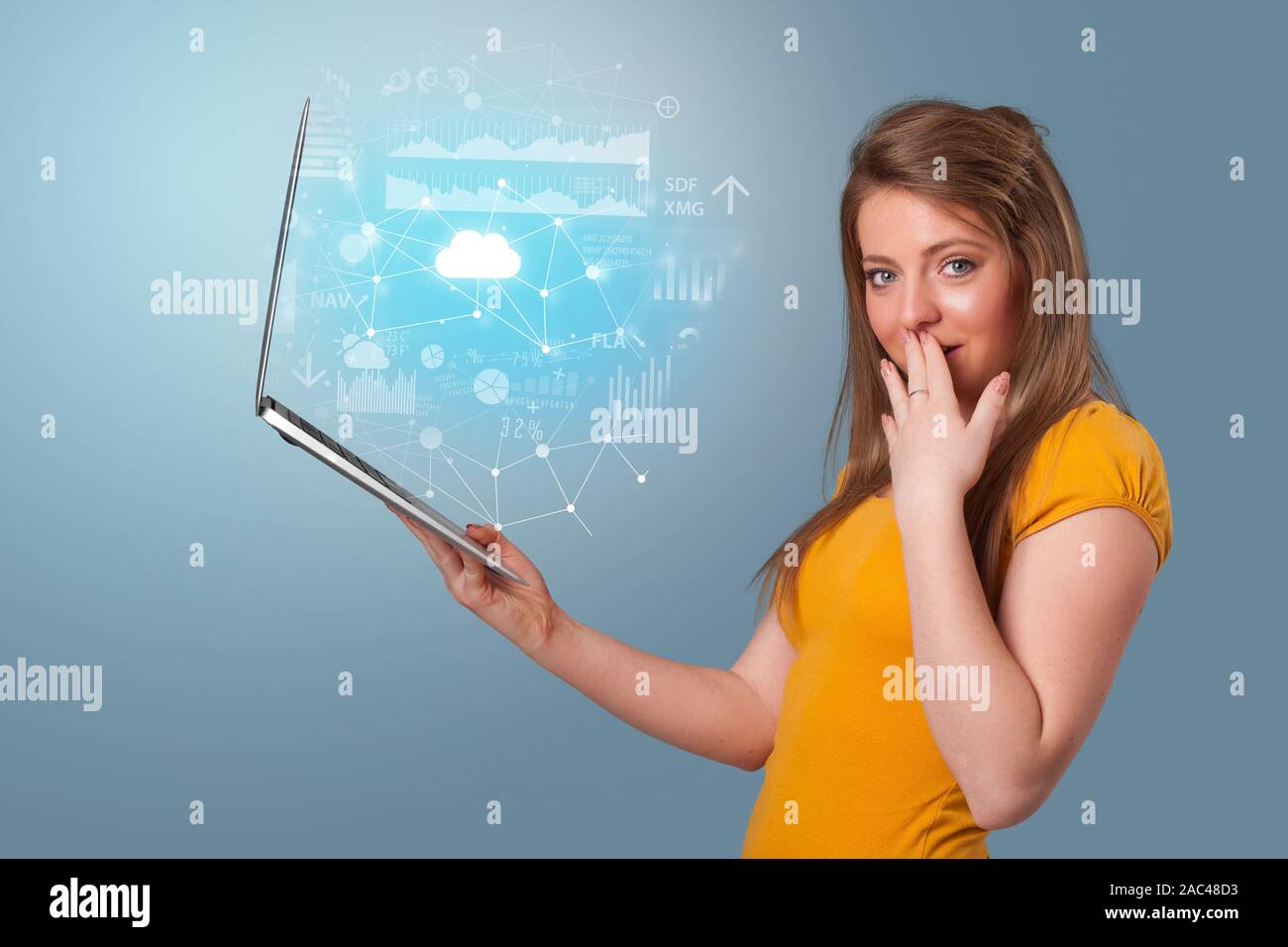 Woman holding laptop projecting cloud based system symbols and ...