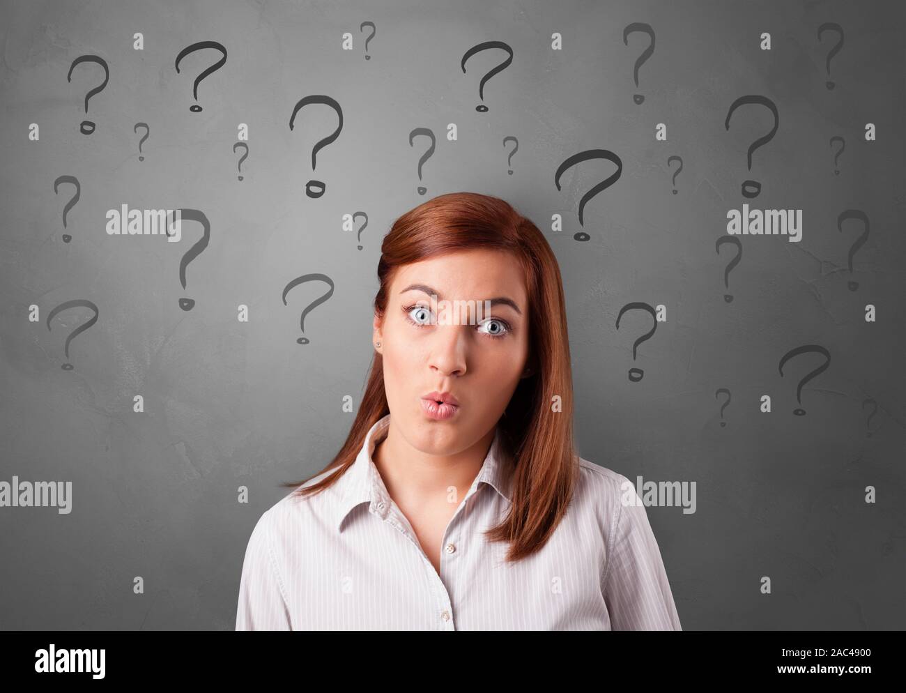 Person with question marks around face Stock Photo - Alamy