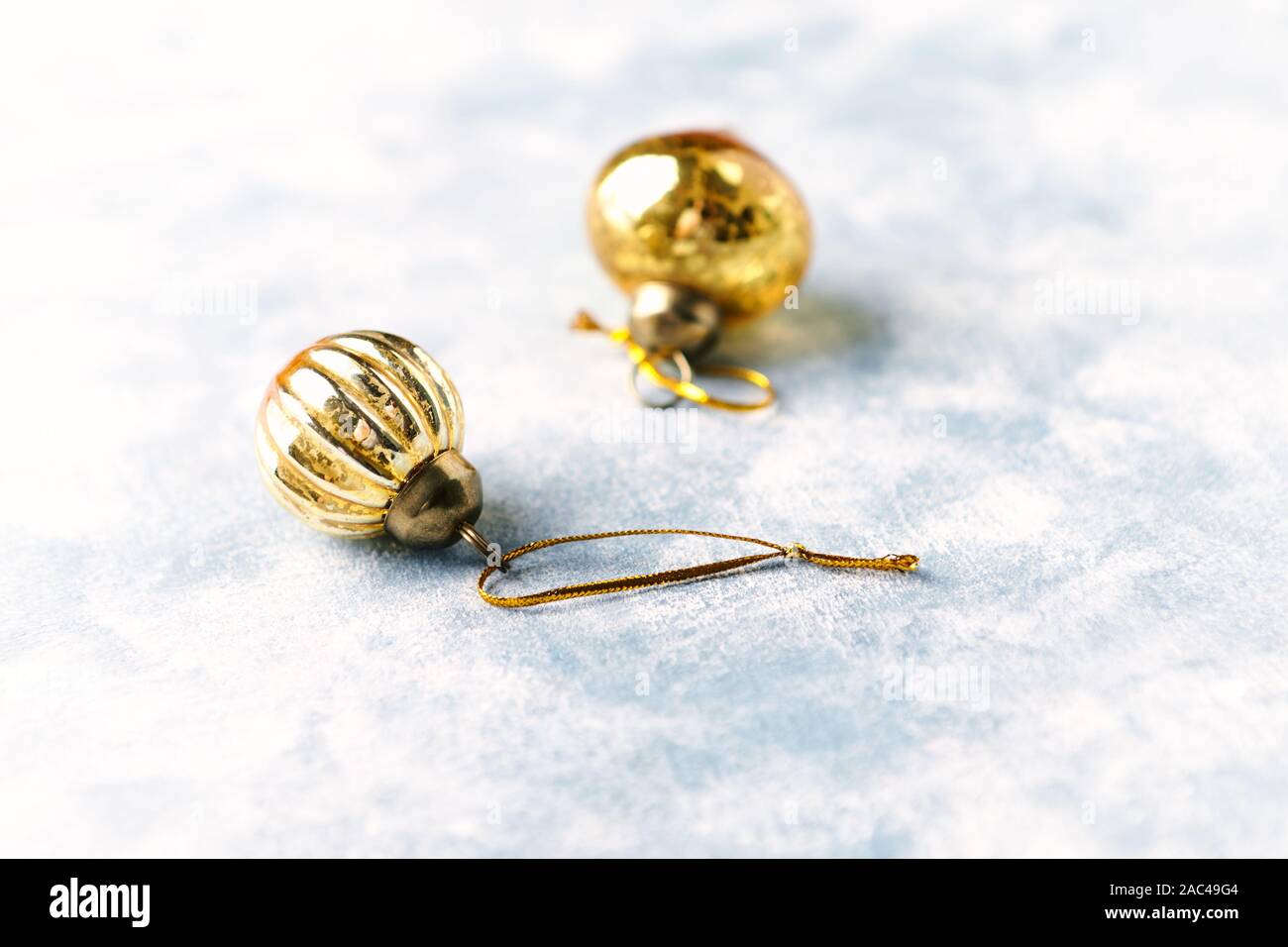 Christmas golden baubles on bright wooden background. Close up. Copy ...