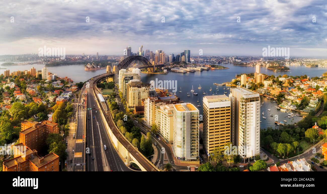 Waterfront of Sydney city CBD on shores of Sydney harbour connected by ...