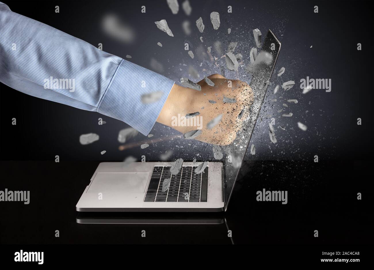 Strong male hand breaks laptop screen Stock Photo - Alamy