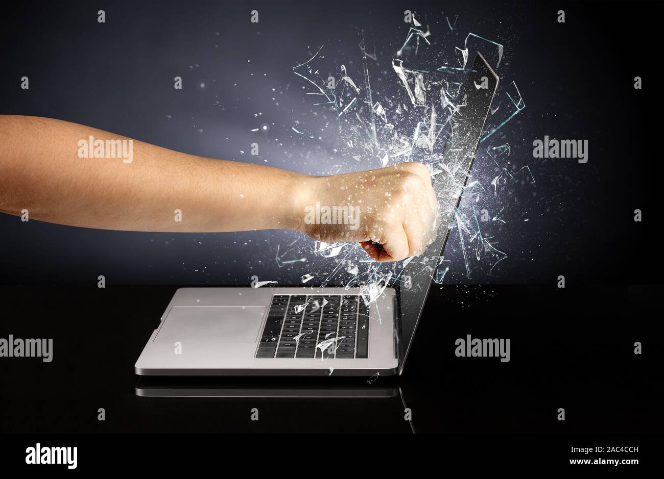 Hand hitting strongly laptop screen glass Stock Photo - Alamy