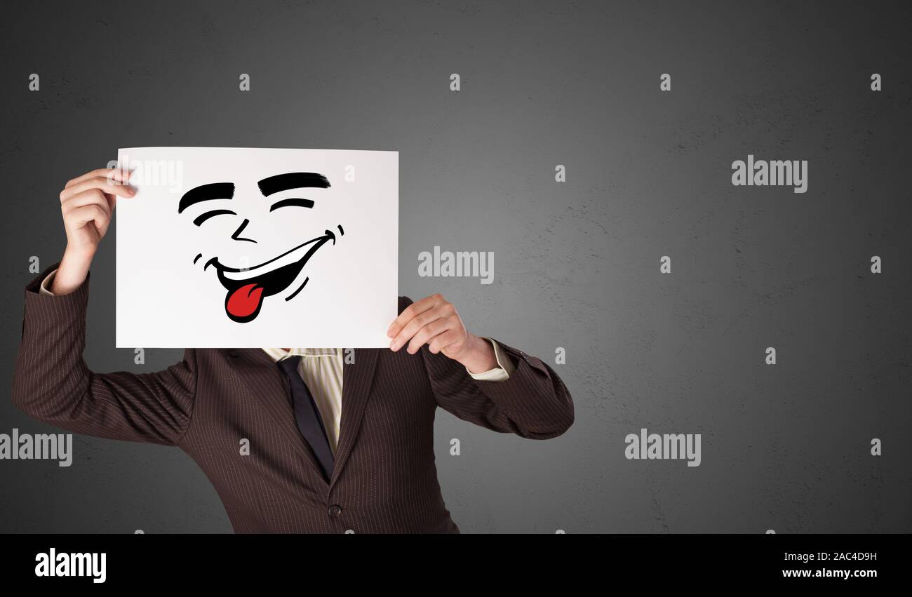 Casual person holding a paper with cool emoticon in front of his face ...
