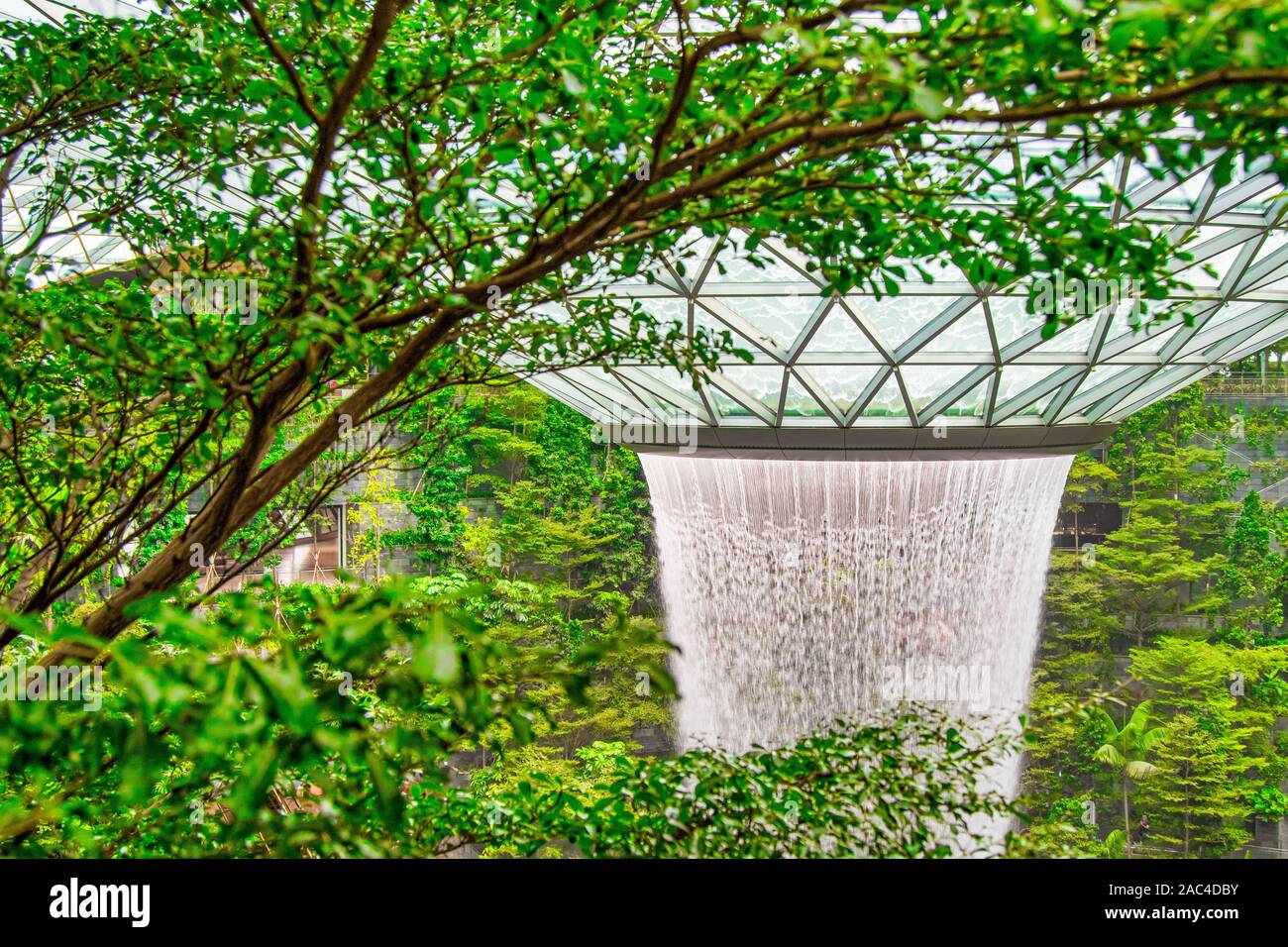 The Jewel Changi waterfall as seen through the trees Stock Photo - Alamy
