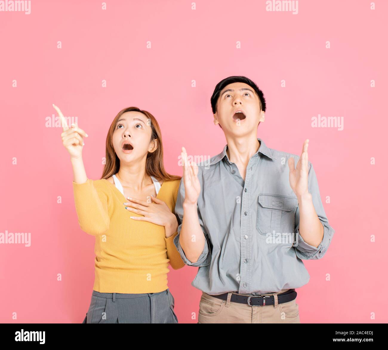 Shocked and surprised young couple looking up Stock Photo - Alamy
