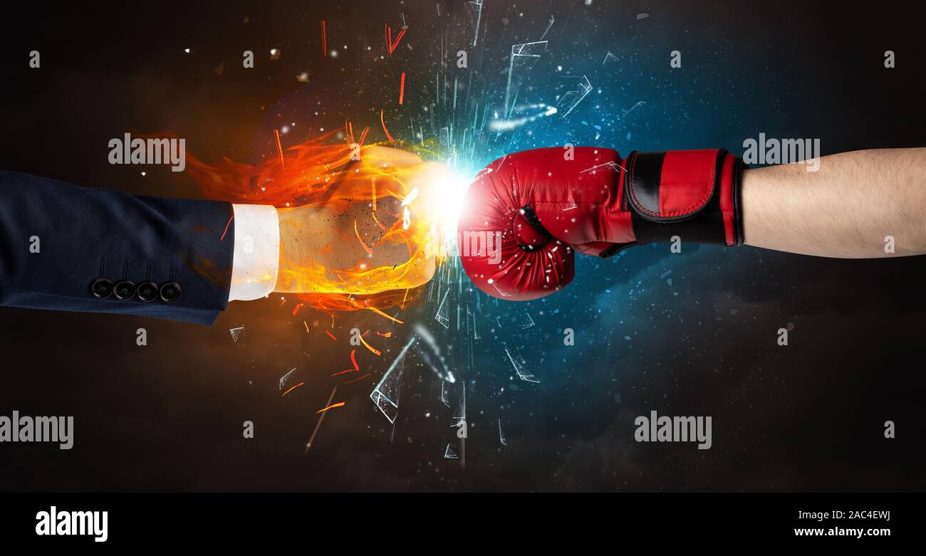 Two hands fighting and breaking glass into small pieces with fire and ...
