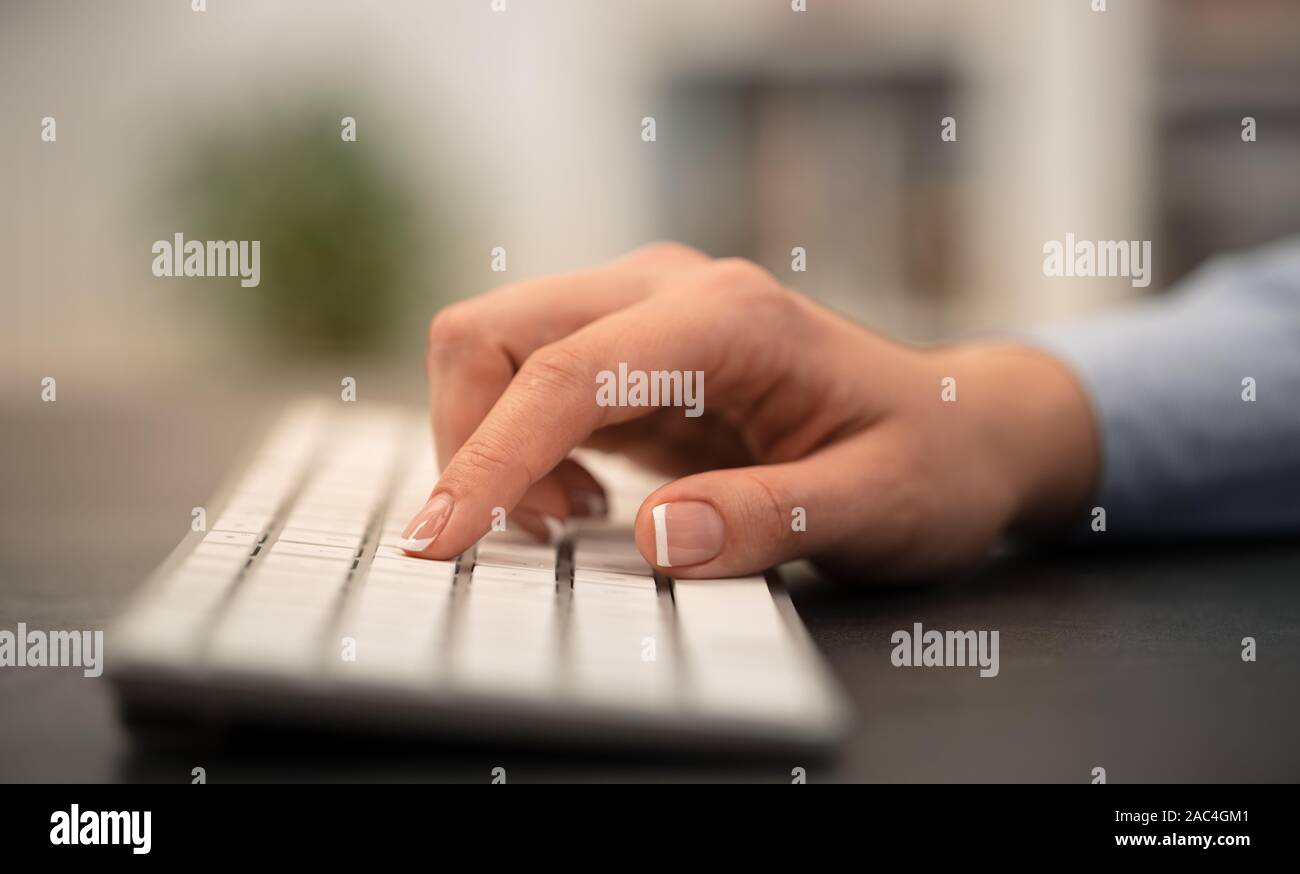 Hand typing on keyboard with office concept Stock Photo - Alamy