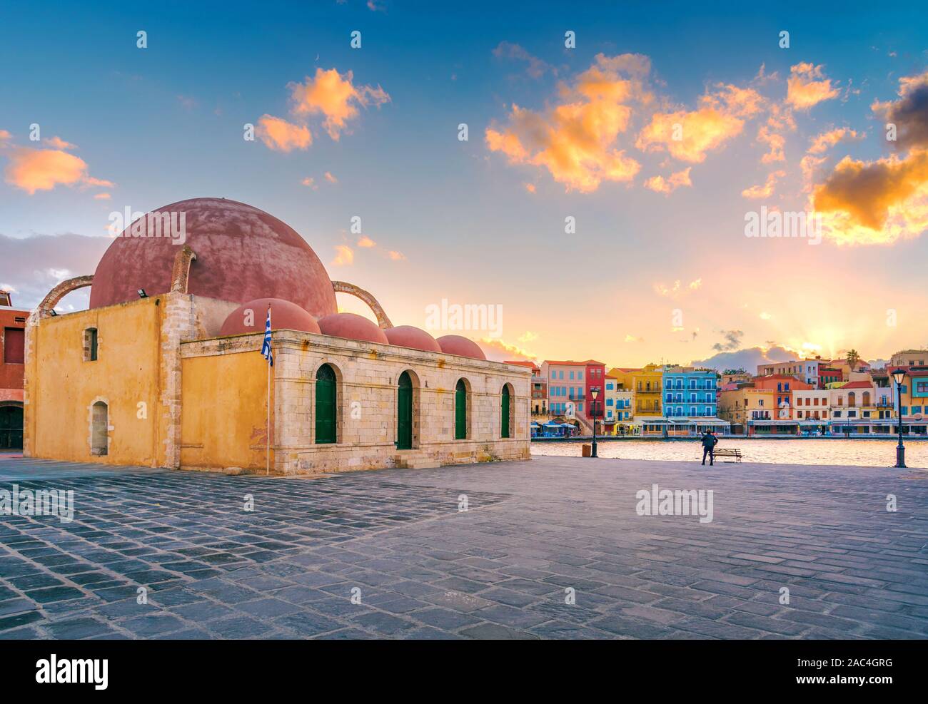 The beautiful old harbor of Chania with the amazing mosque, at sunset ...