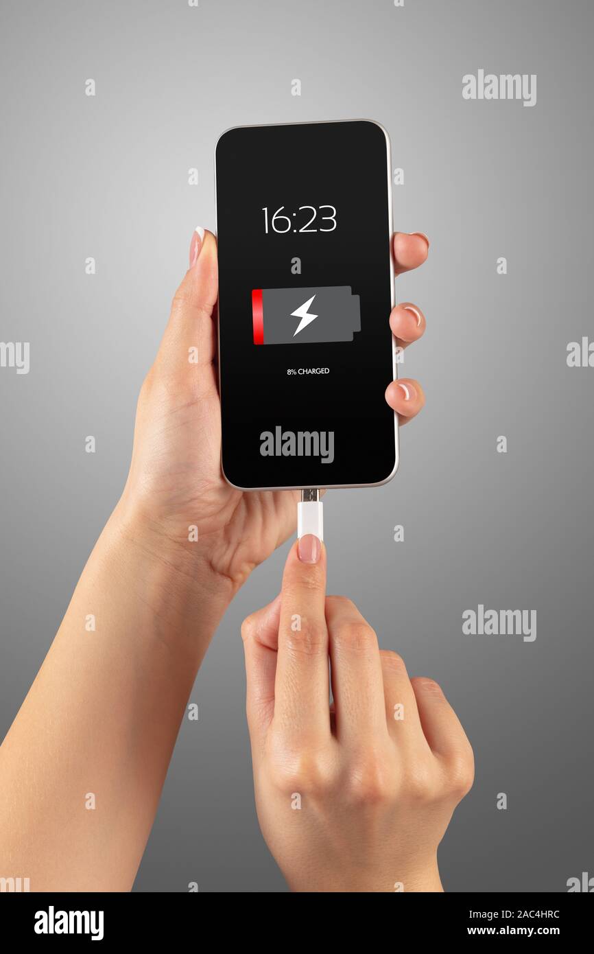 Elegant hand charging smartphone hi-res stock photography and images ...