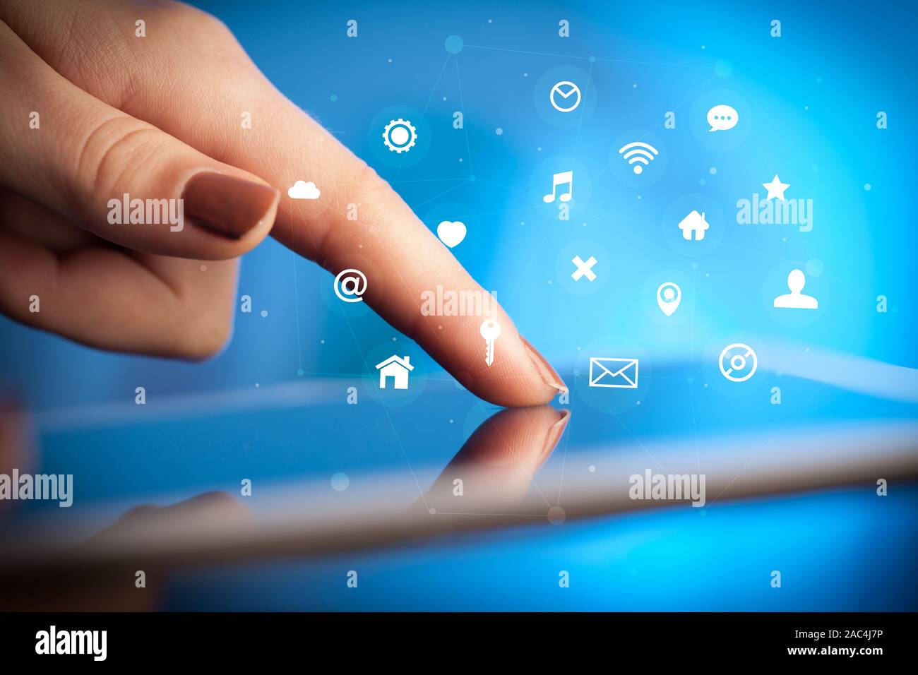 Hand holding tablet with multimedia and application symbols concept ...