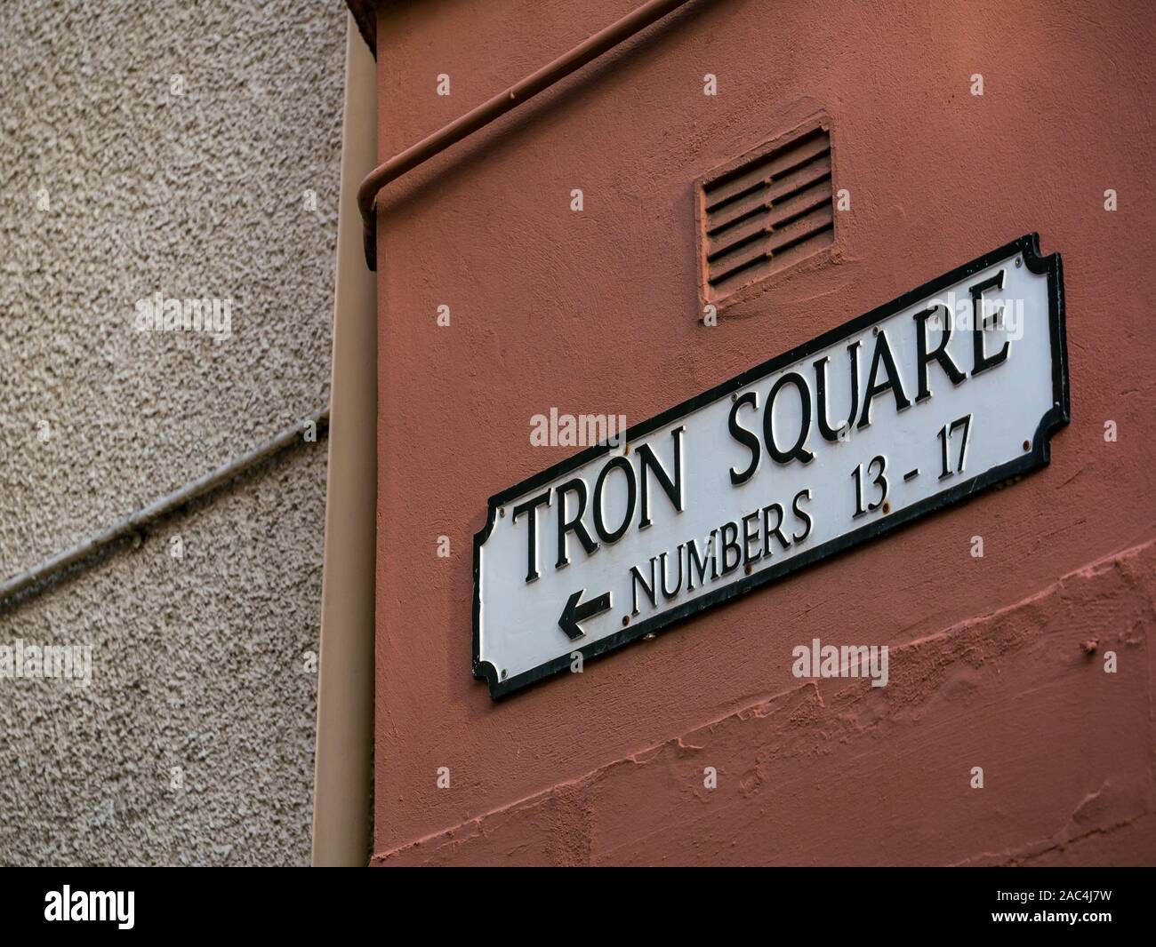 Tron Square name sign on wall with arrow pointing to numbered ...