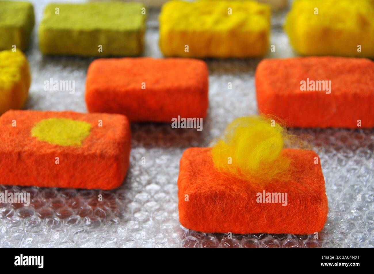 Bars of soap being covered with felt in a wet felting process Stock ...