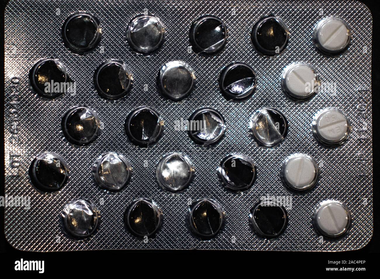 Perscription drugs under blue light in plastic metal wrapper Stock ...