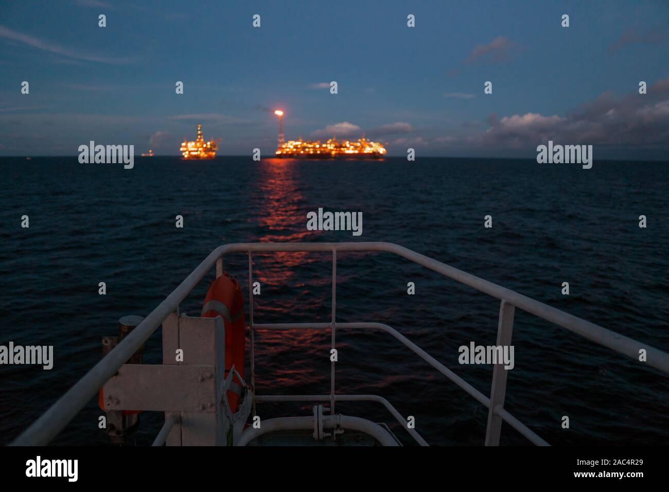 FPSO tanker vessel near Oil Rig platform. Offshore oil and gas industry ...