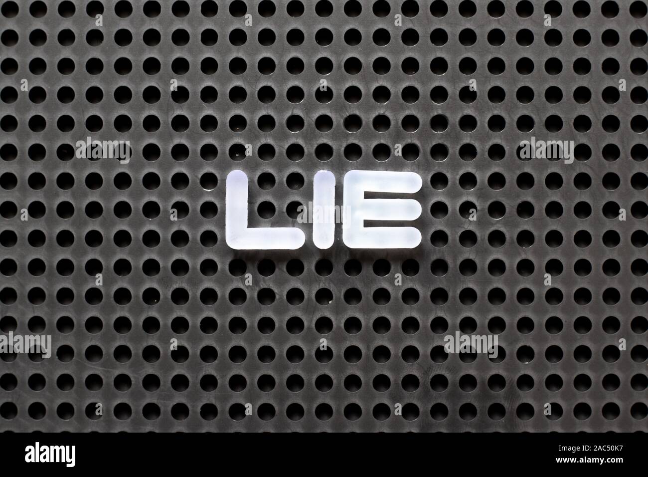 Black color pegboard with white letter in word lie Stock Photo - Alamy