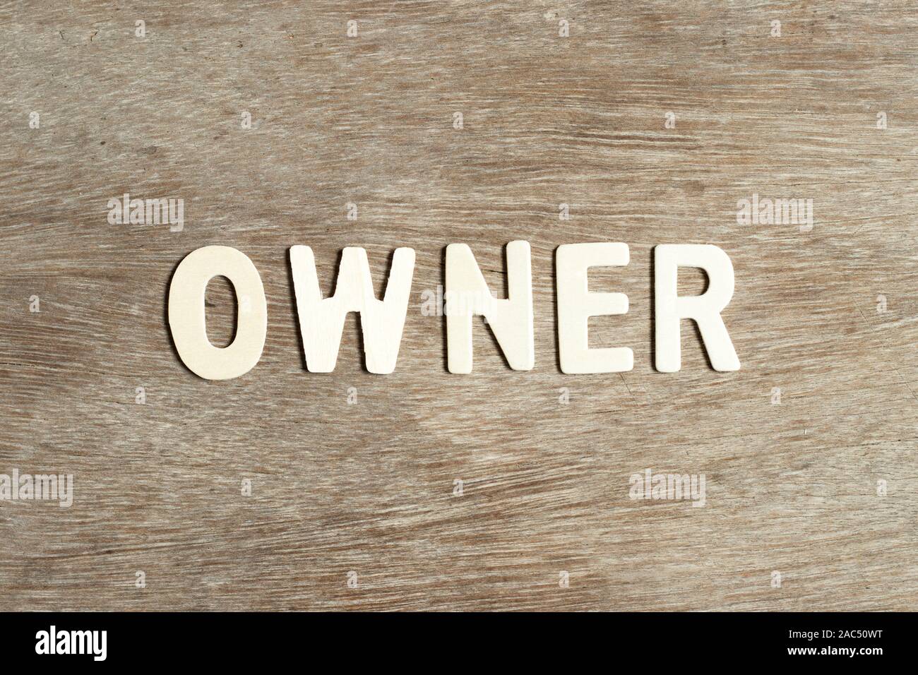 Alphabet letter in word owner on wood background Stock Photo - Alamy