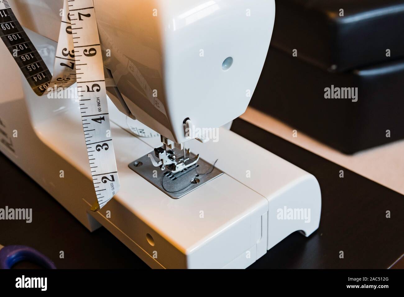Sewing machine needle with measuring tape Stock Photo - Alamy