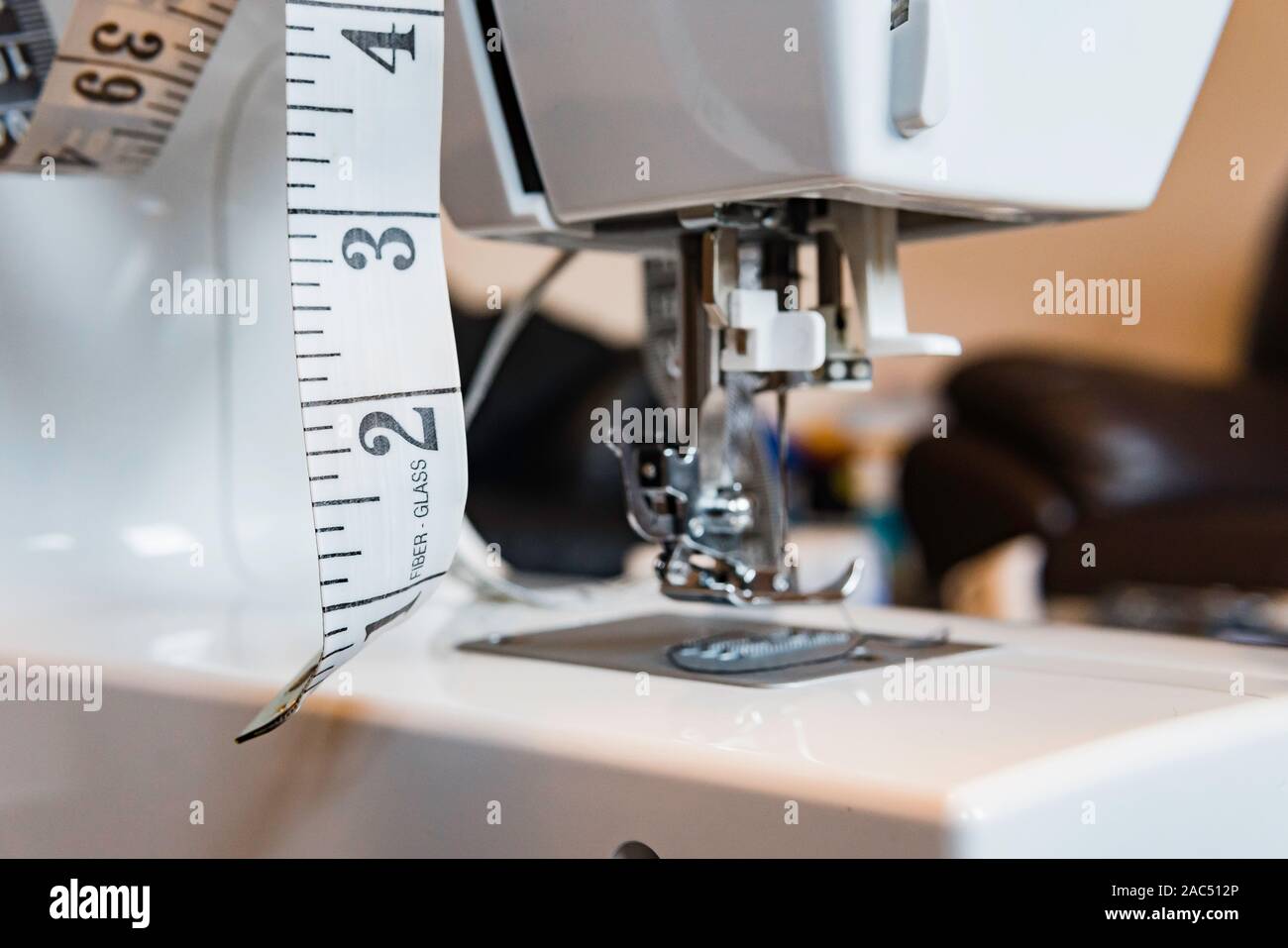 Sewing machine needle with measuring tape Stock Photo - Alamy