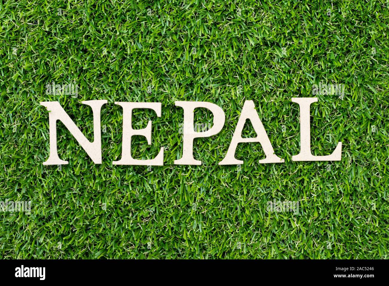 Wood alphabet letter in word Nepal on green grass background Stock ...