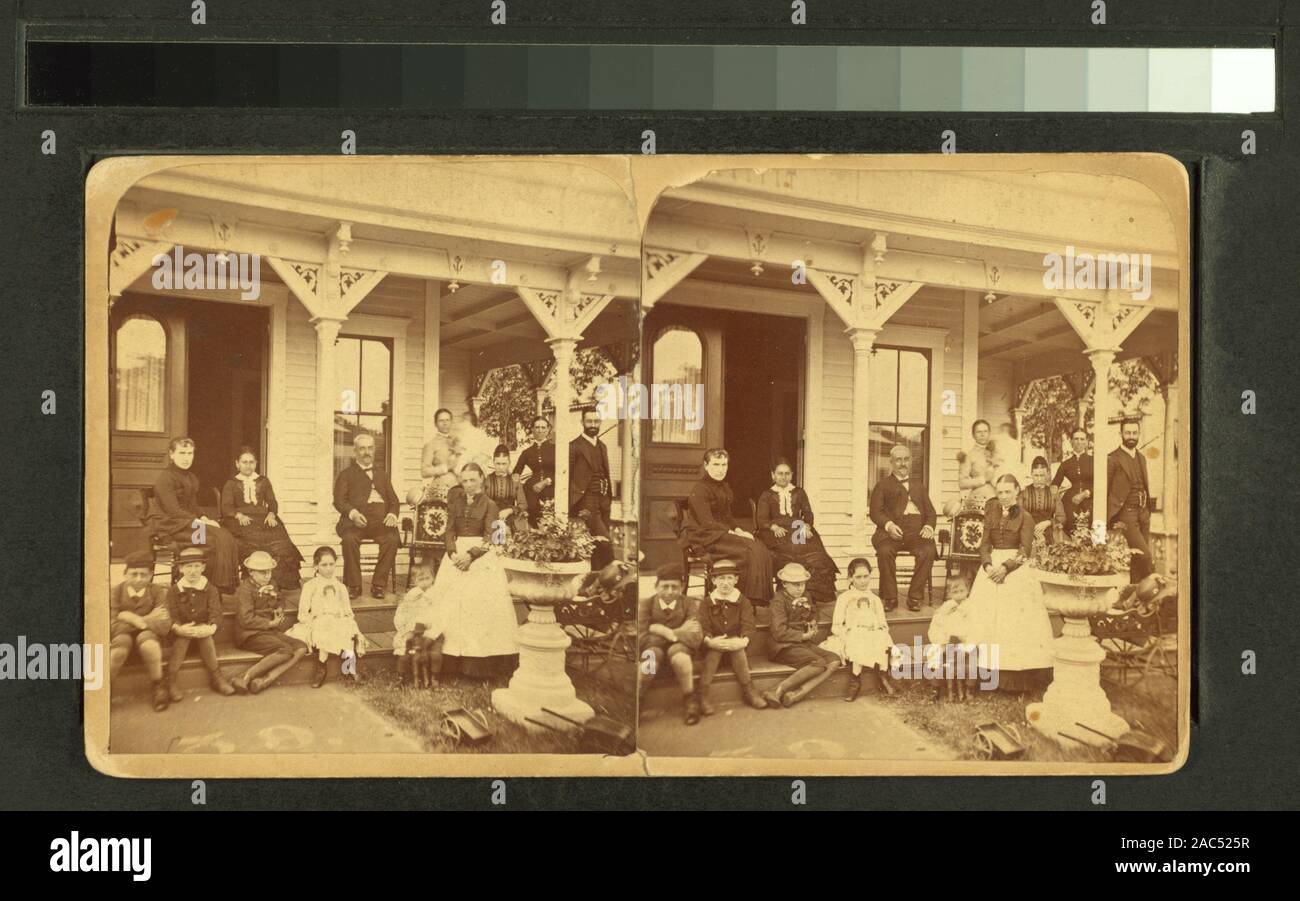 Group posing on the porch of a cottage Group posing on the porch of a ...