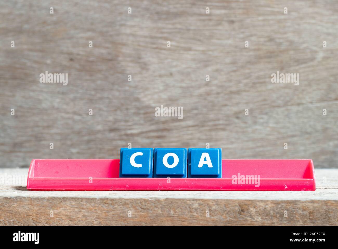 Tile letter on red rack in word COA (abbreviation of certificate of ...