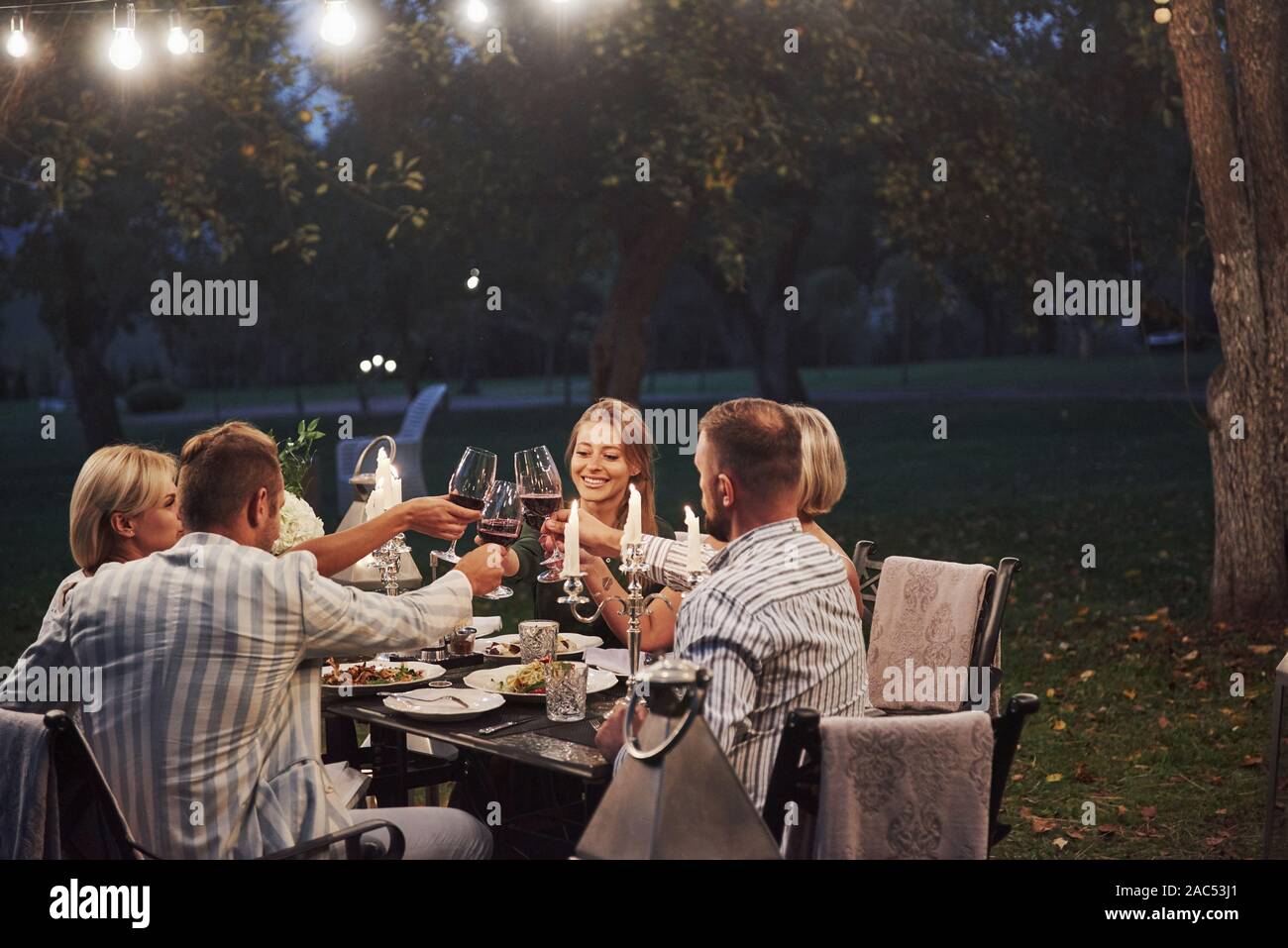 Family weekend. Evening time. Friends have a dinner in the gorgeous ...