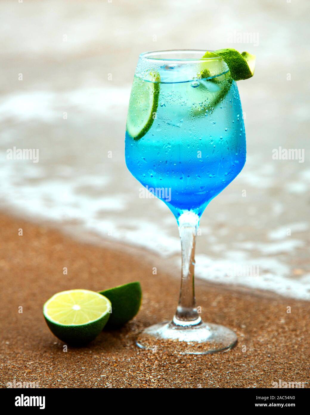 blue drink with lime on sea shore Stock Photo - Alamy