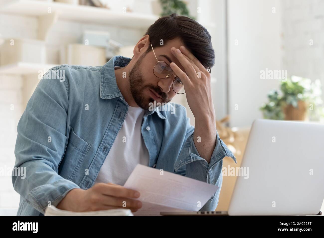 Upset frustrated young man holding reading postal mail letter Stock ...