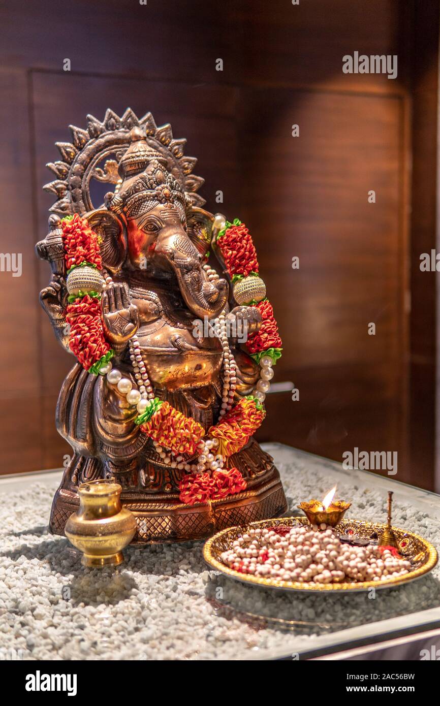Hindu Statue of Ganesh, god of luck and remover of obstacles with fire ...