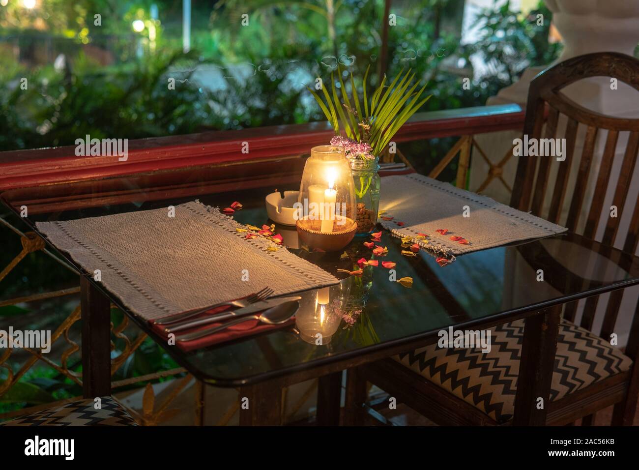Romantic Dinner with Candle and Flowers in Goa, India Stock Photo - Alamy